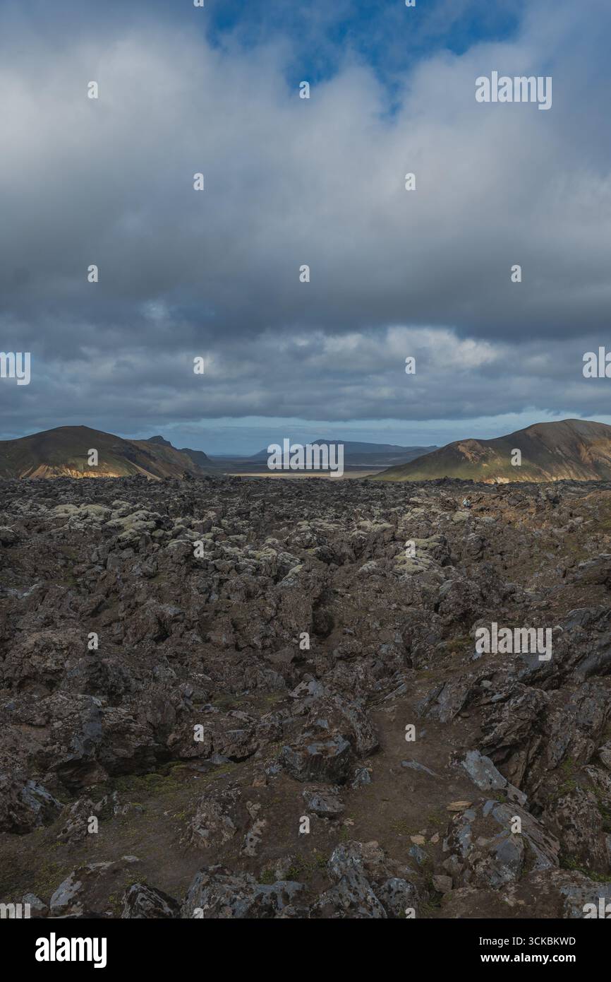 Rugged volcanic terrain in Iceland with jagged lava rocks, moss patches ...