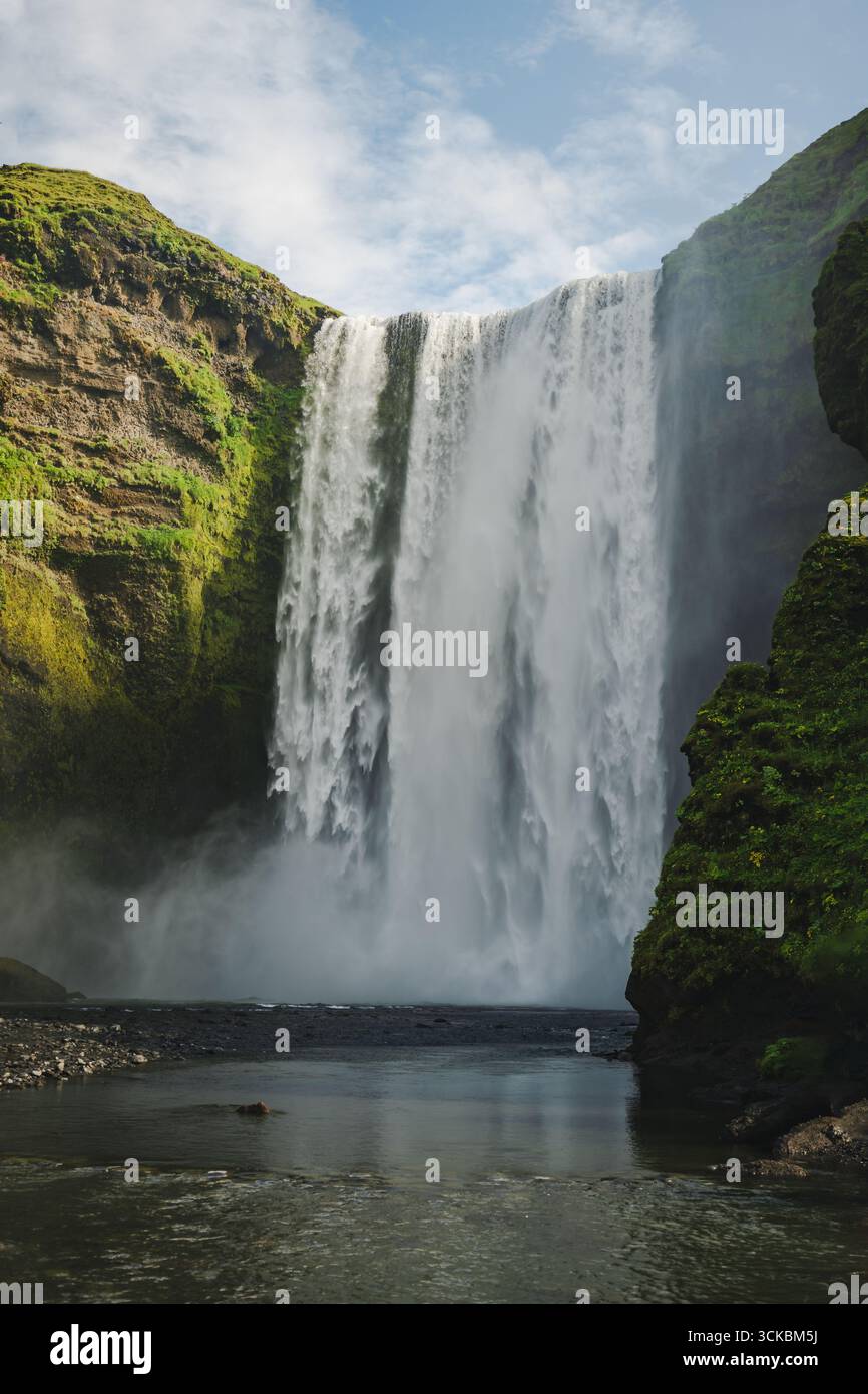 Skogafoss waterfall cascades 60 meters in Iceland, framed by mossy ...