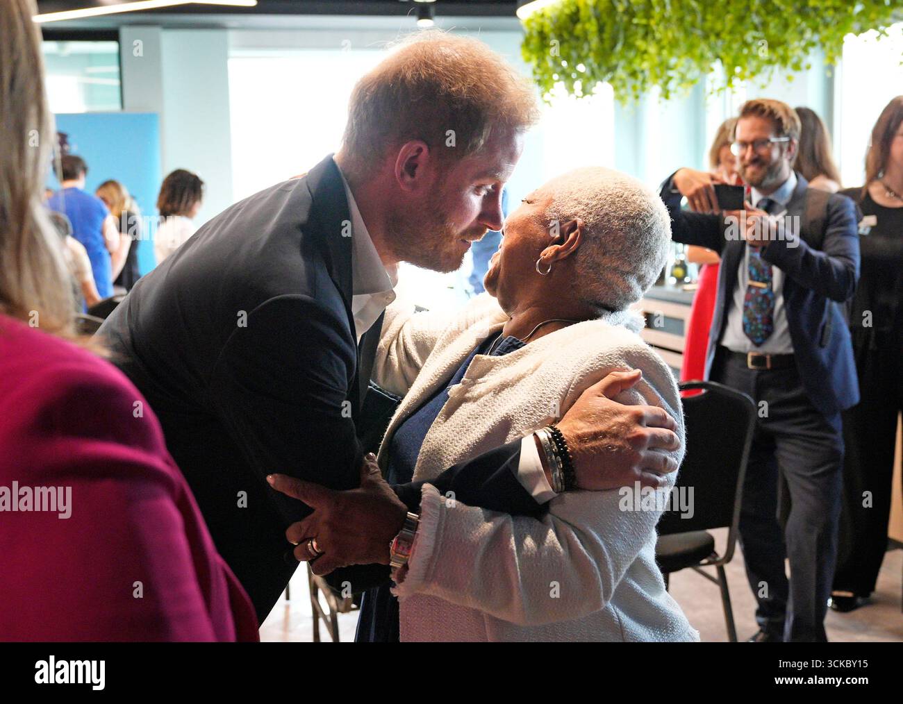 The Duke of Sussex hugs Colleen Harris, a trustee of the king Charles ...