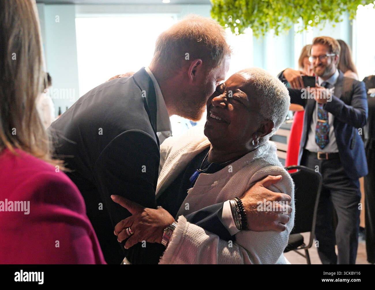 The Duke of Sussex hugs Colleen Harris, a trustee of the king Charles ...