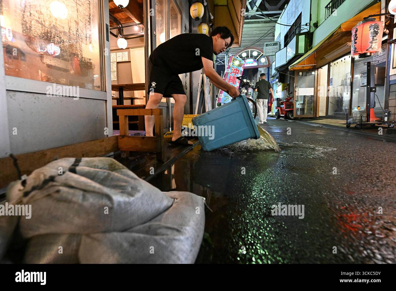 Employees at a restaurant flooded above floor level due to heavy rain ...