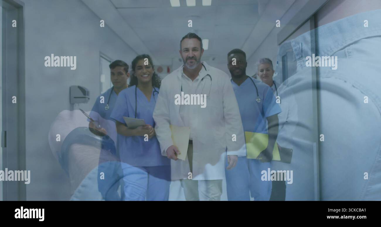 Walking medical team wearing scrubs and lab coats while holding ...
