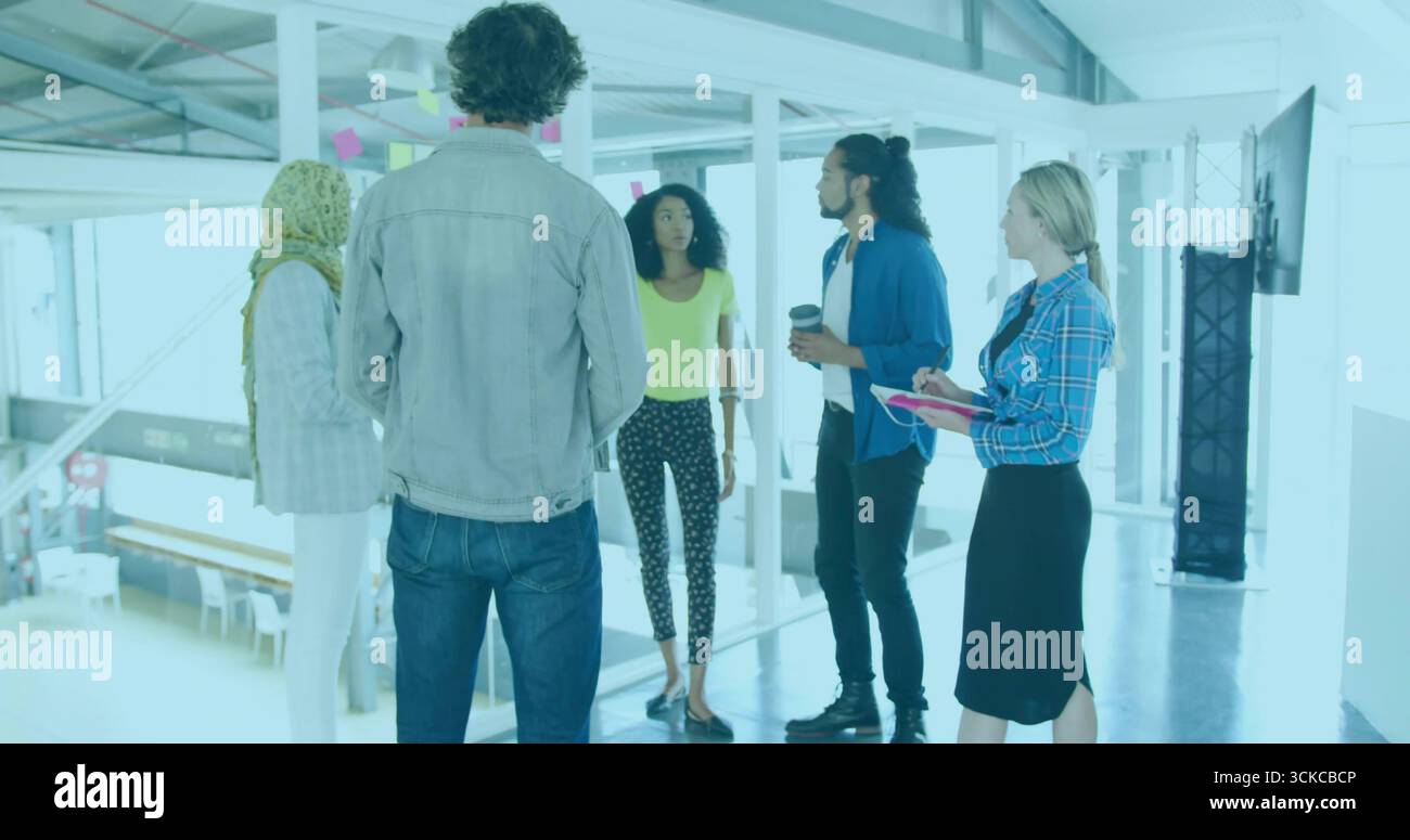 Business professionals brainstorming around glass partition in office ...