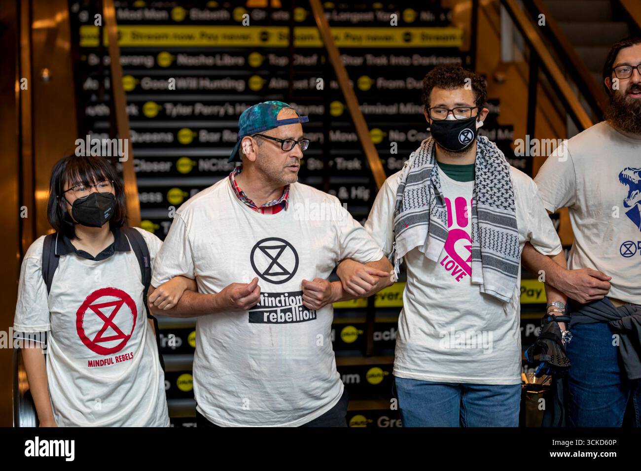 Climate activists with Extinction Rebellion block escalators inside CBS ...