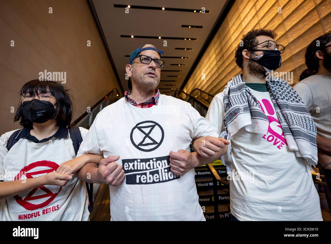 Climate activists with Extinction Rebellion block escalators inside CBS ...