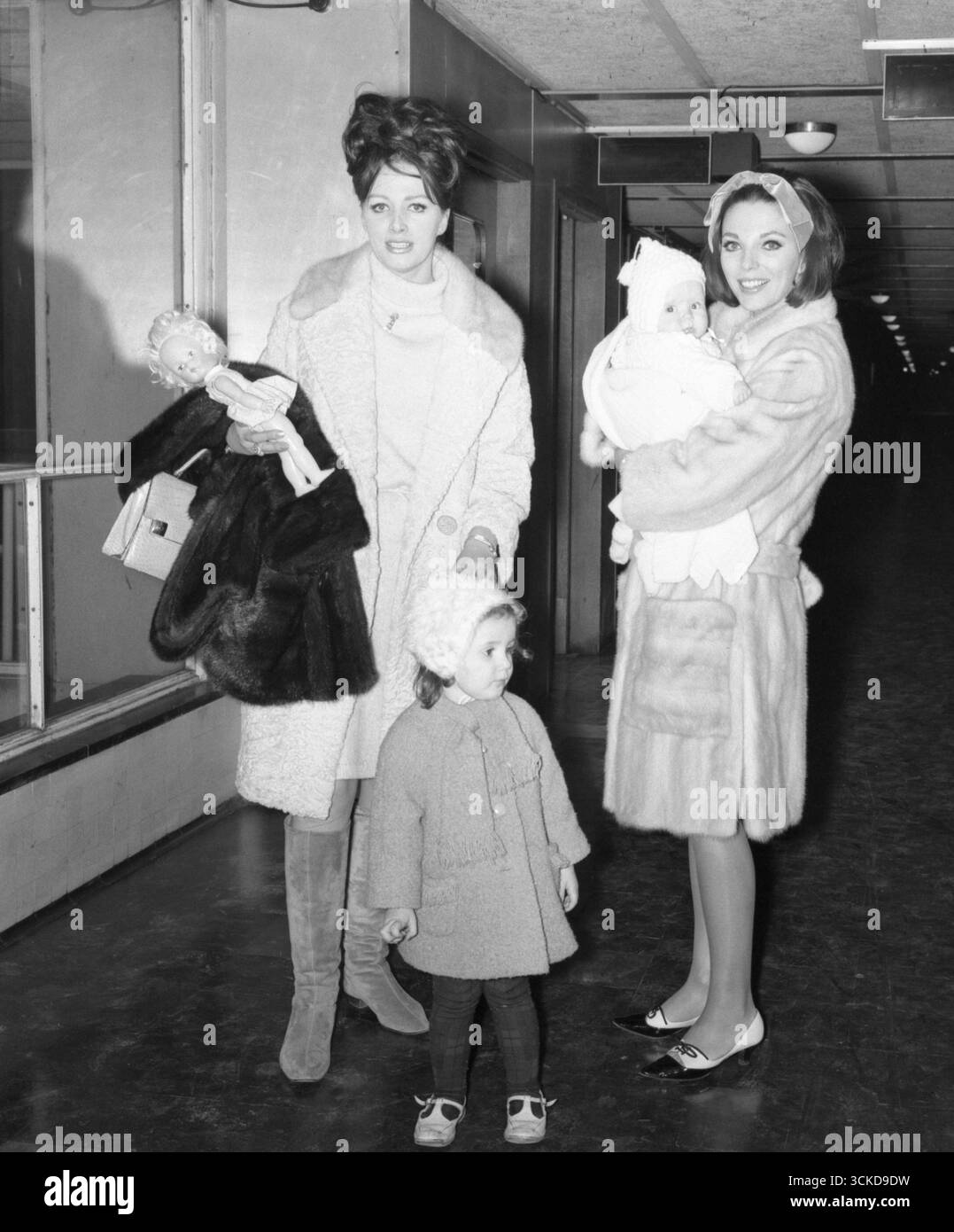 Joan Collins, right, holds her four month old daughter Tara as she ...