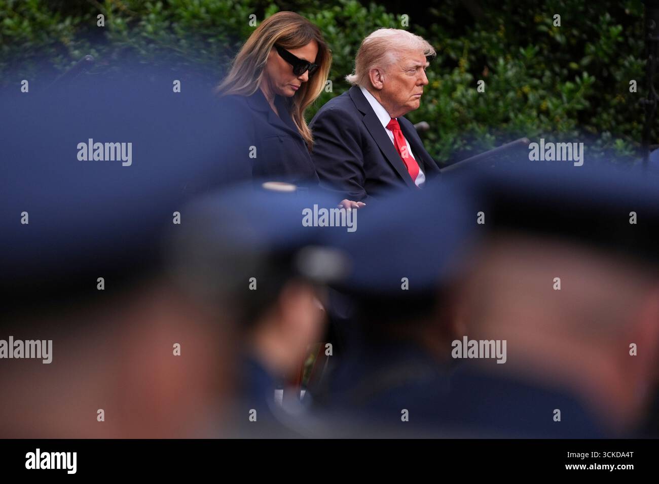 President Donald Trump and first lady Melania Trump listen as names are ...
