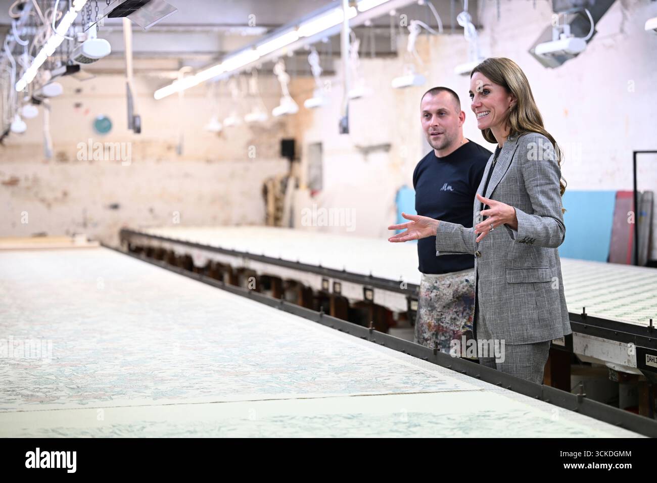 Britain's Kate, Princess of Wales, right, looks at a screen print ...