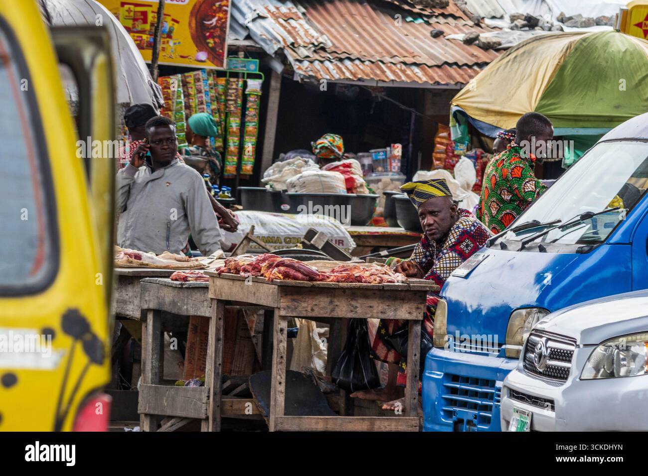 A Nigerian butcher with fresh cow meat at a public garage in Lagos ...