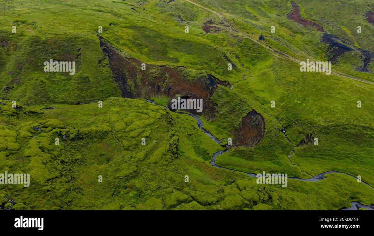 Aerial perspective of Iceland's volcanic terrain with deep fissures ...