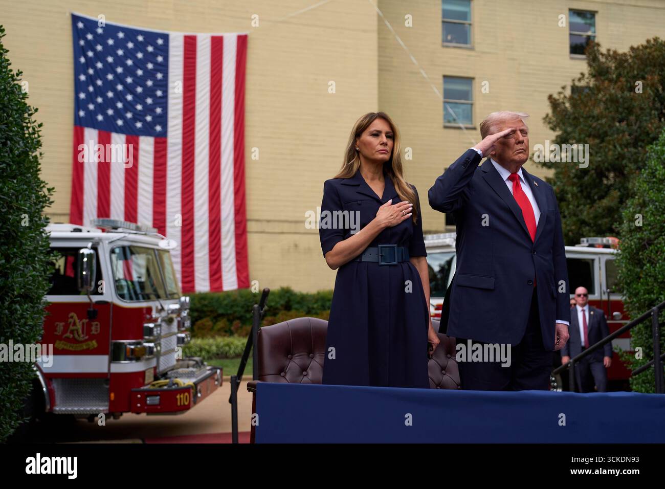 President Donald Trump and first lady Melania Trump stand as Taps is ...