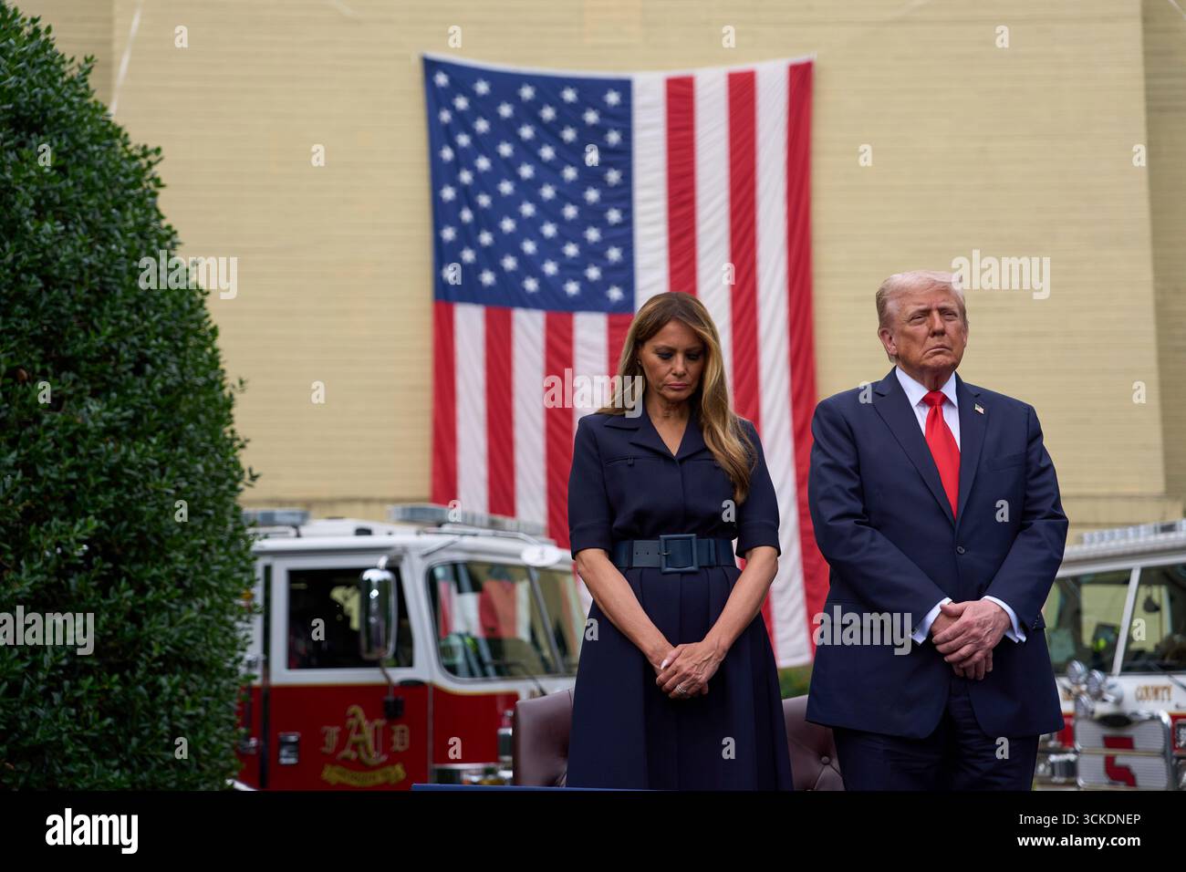 President Donald Trump and first lady Melania Trump stand for a moment ...