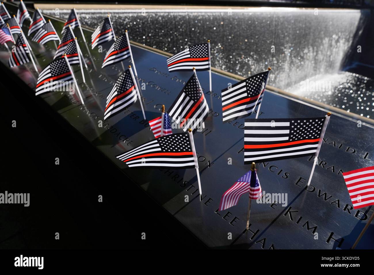 Flags are seen on the 9/11 Memorial during a ceremony to mark the 24th ...