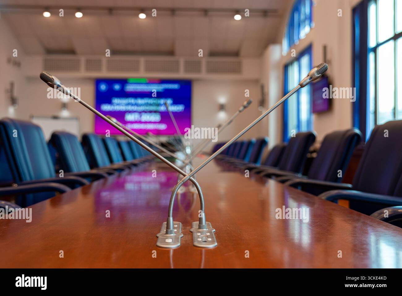 Modern conference room with long table and twin microphones Stock Photo ...