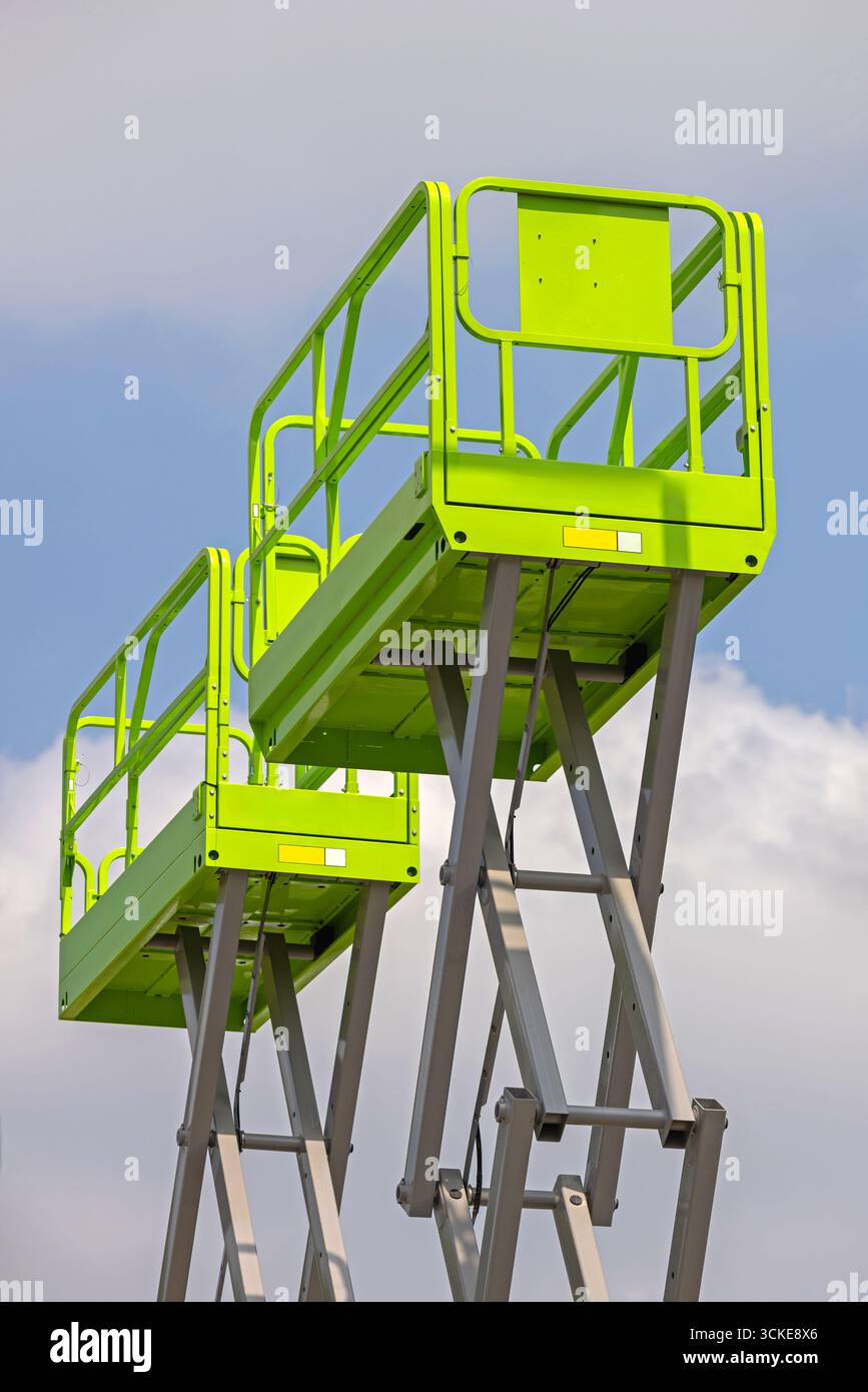 Two Green Scissor Lift Elevated Work Platform at Construction Site ...