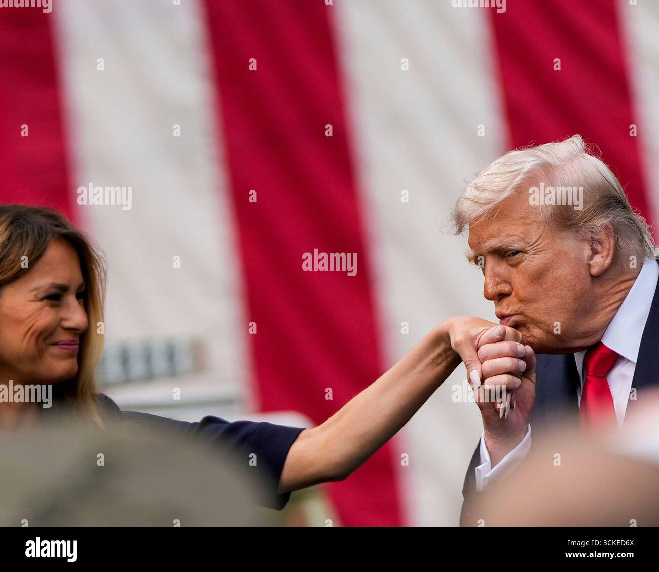 President Donald Trump kisses first lady Melania Trump's hand during a ...