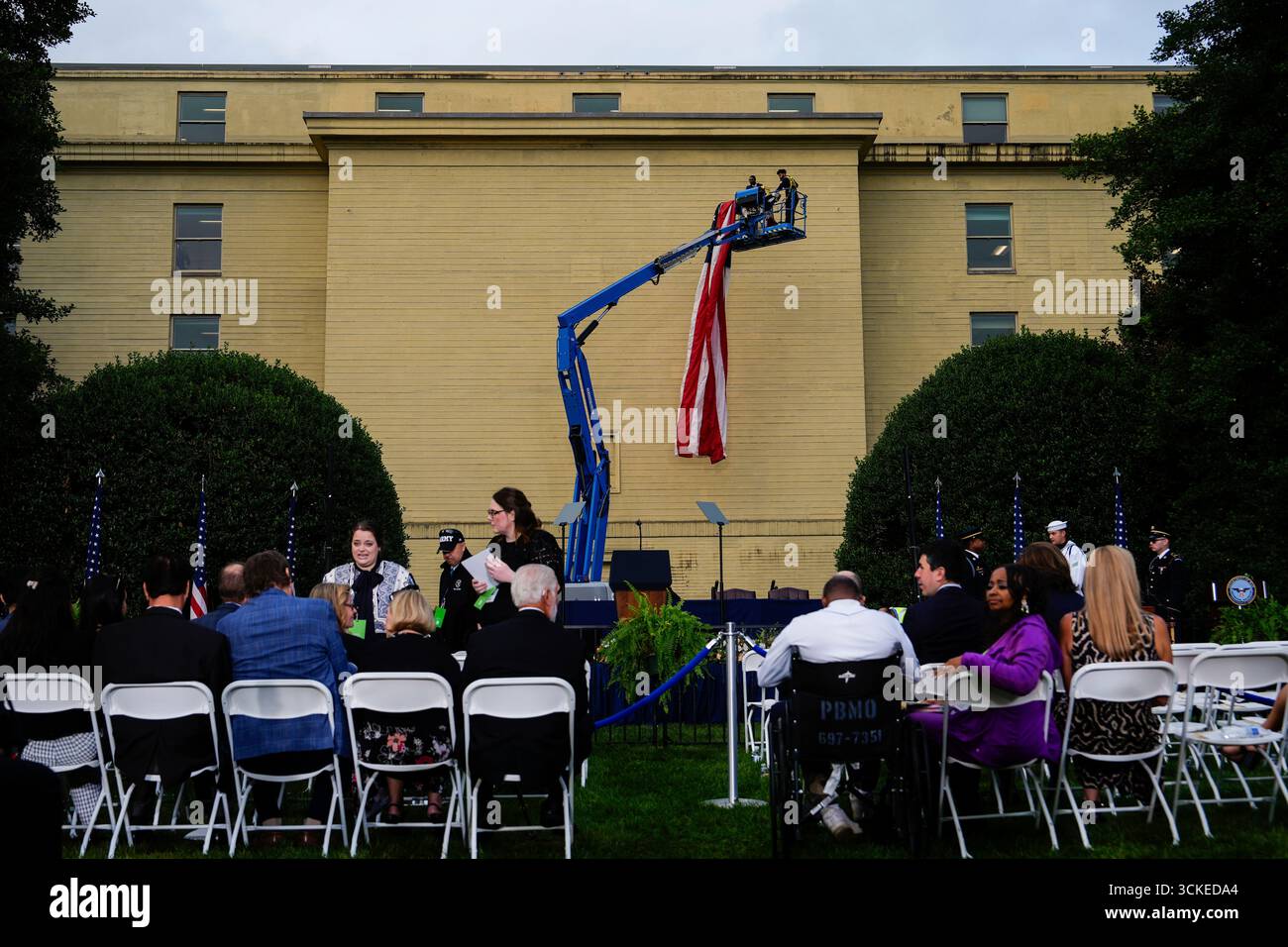 An American flag is hung before a ceremony in the Pentagon courtyard to commemorate the 24th ...