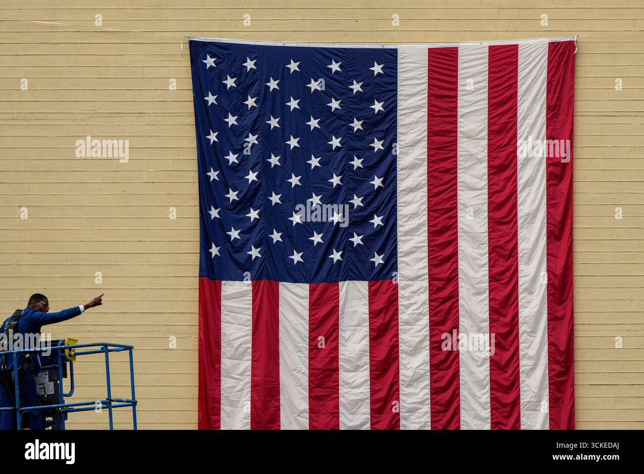An American flag is hung before a ceremony in the Pentagon courtyard to commemorate the 24th ...