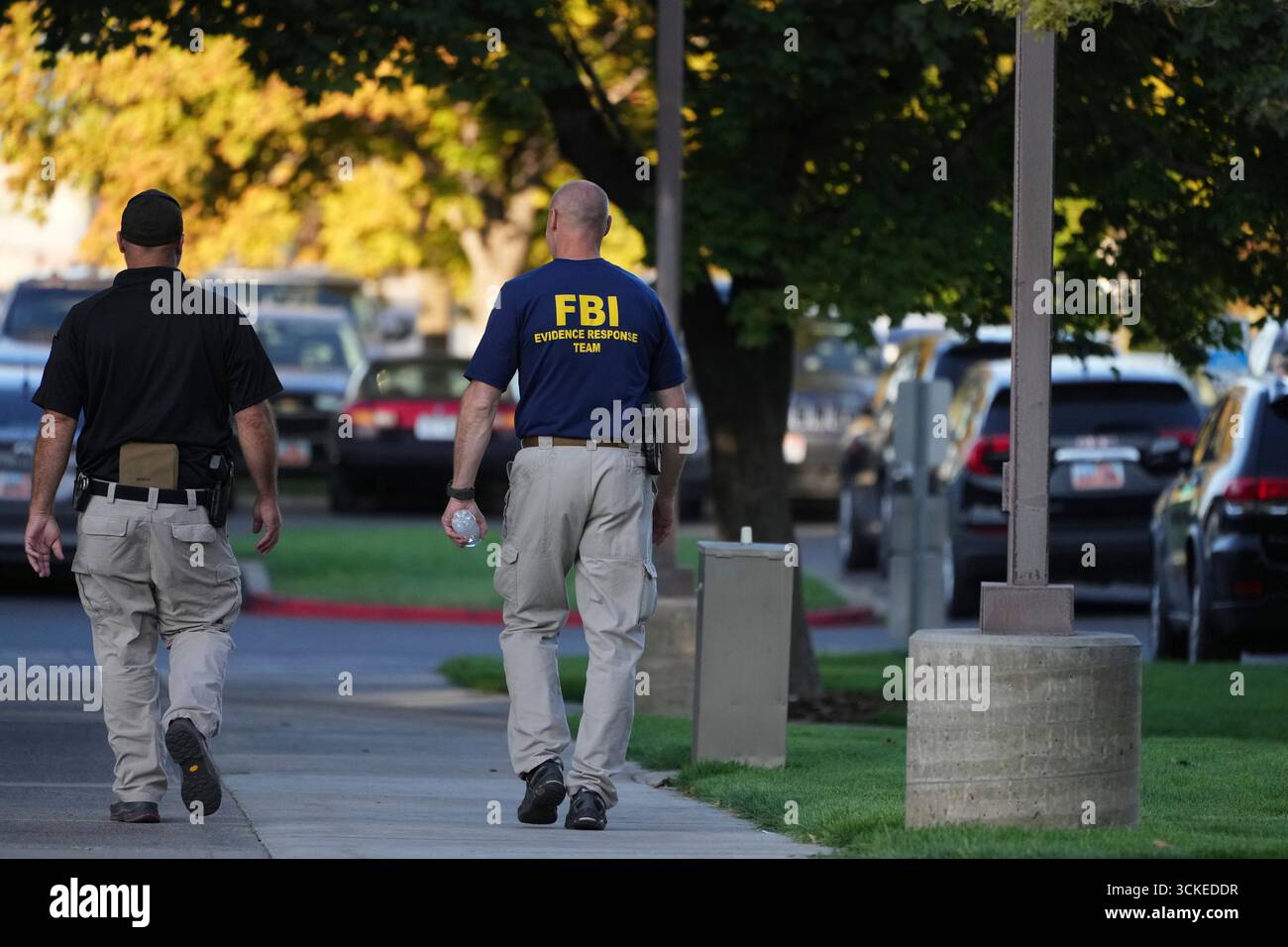 FBI and law enforcement walk outside the campus at Utah Valley ...