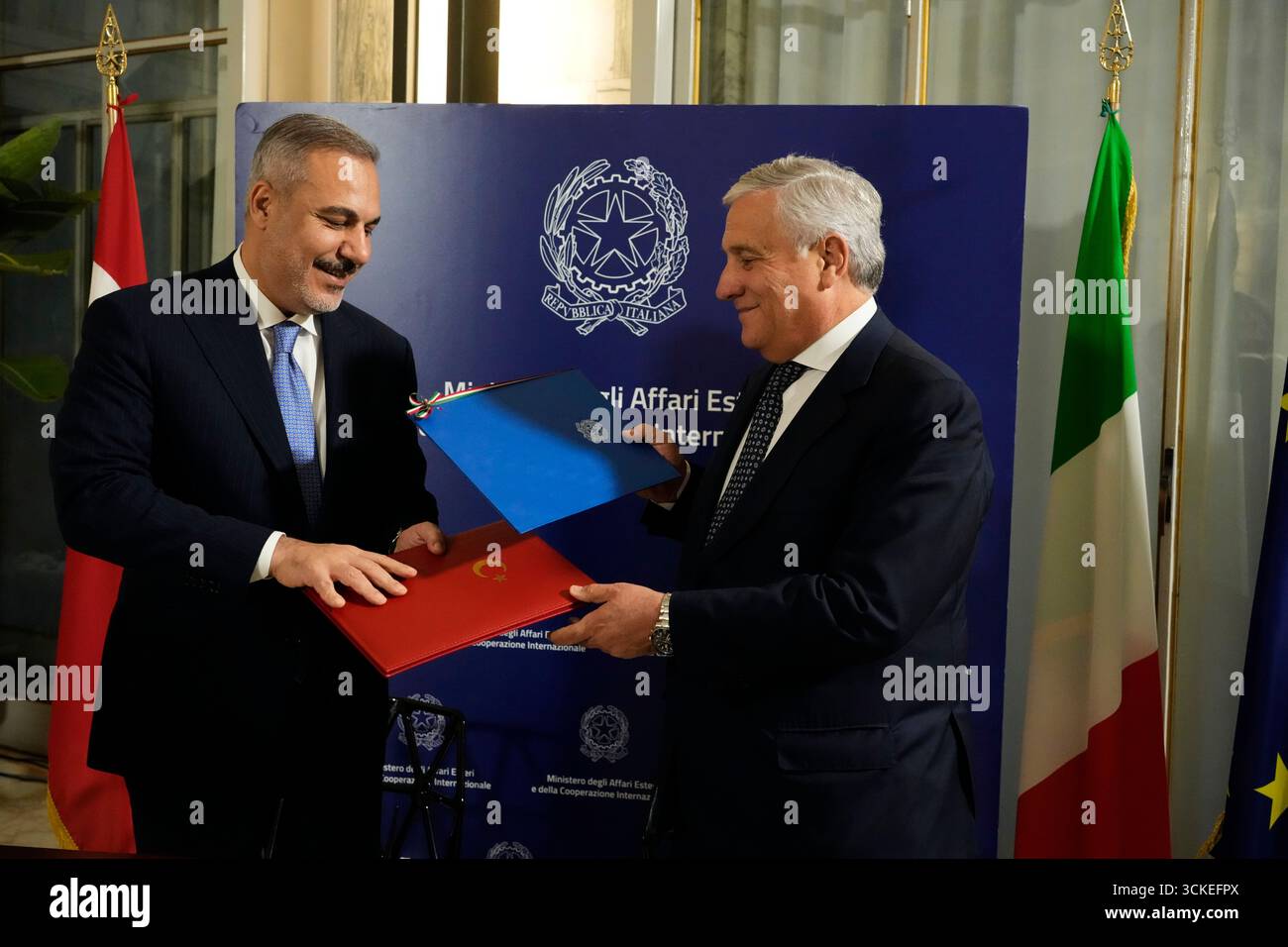 Italian Foreign Minister Antonio Tajani is flanked by Turkish ...