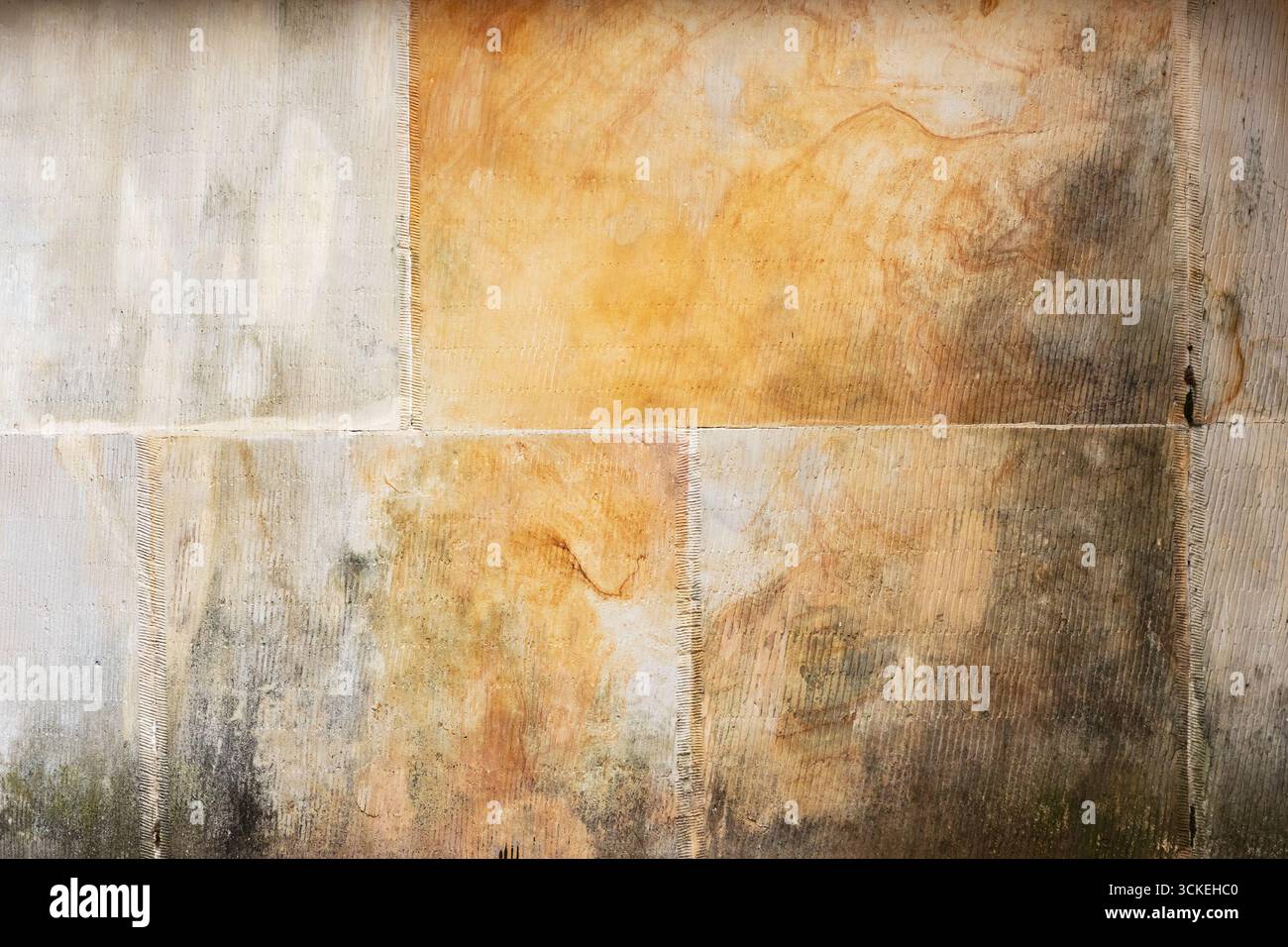 warm‑toned plaster surface with multiple panel seams, natural ...