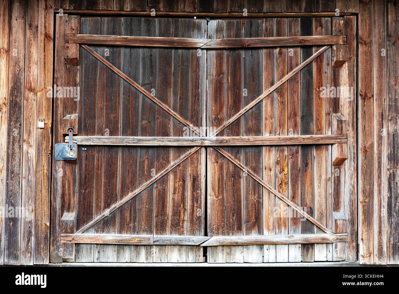 Pair of rustic sliding barn doors with X‑braced timbers and a simple ...