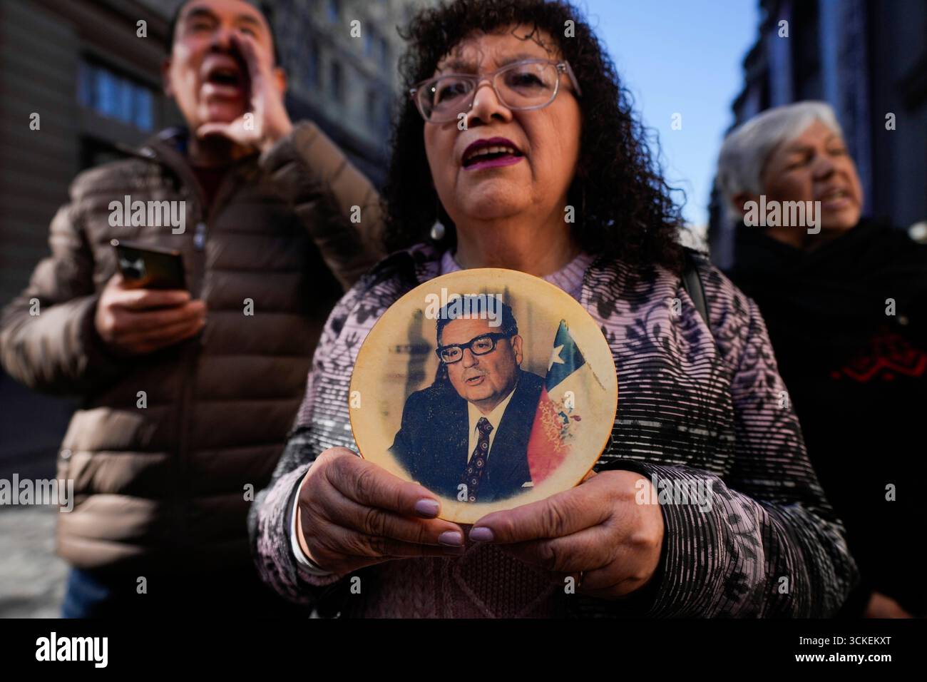 A woman holds a portrait of Chile's late President Salvador Allende as ...