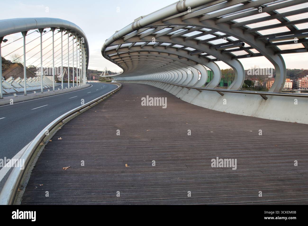 Modern walkway on curved pedestrian bridge - A wide-angle shot of a ...