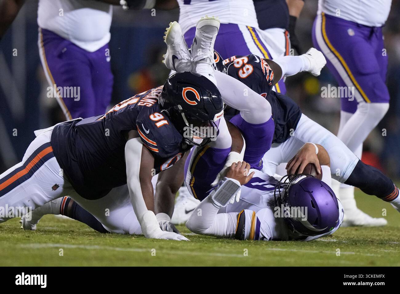 Chicago Bears defensive tackle Chris Williams, bottom, sacks Minnesota ...