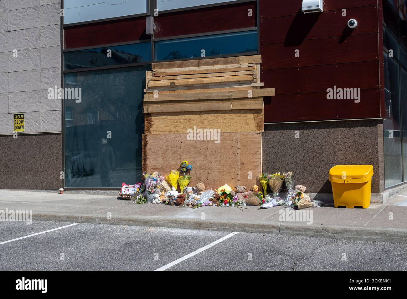 Members of the community leave flowers and toys in front of a damaged ...