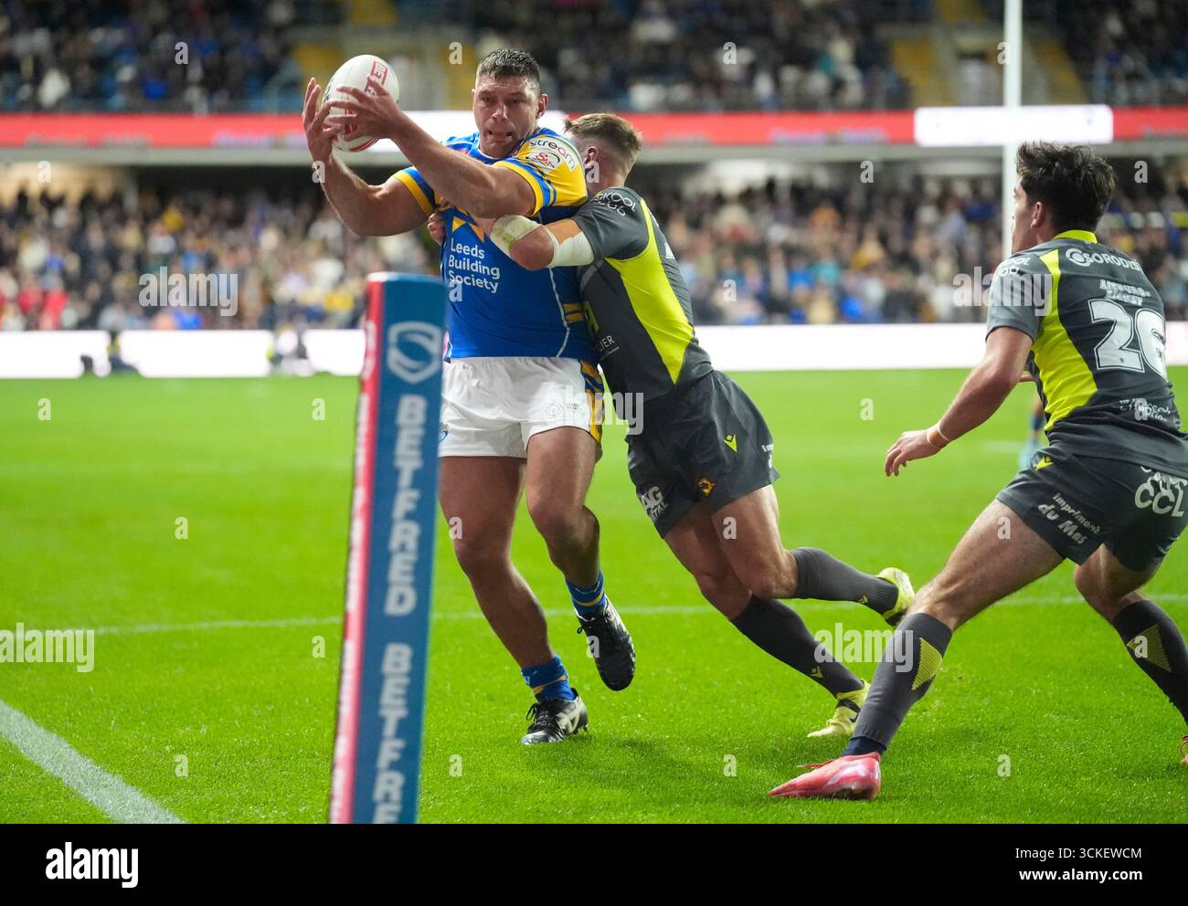 Leeds Rhinos' Ryan Hall (left) is tackled by Catalans Dragons' Tommy ...