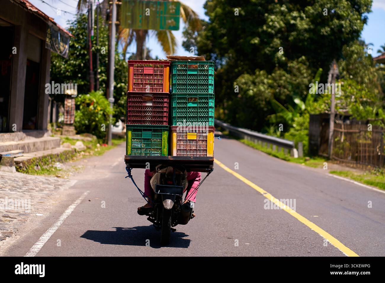 People are riding a heavily loaded motorcycle. Asian people are ...