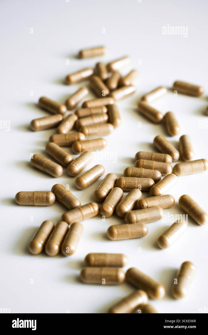 Natural supplement capsules scattered hi-res stock photography and ...