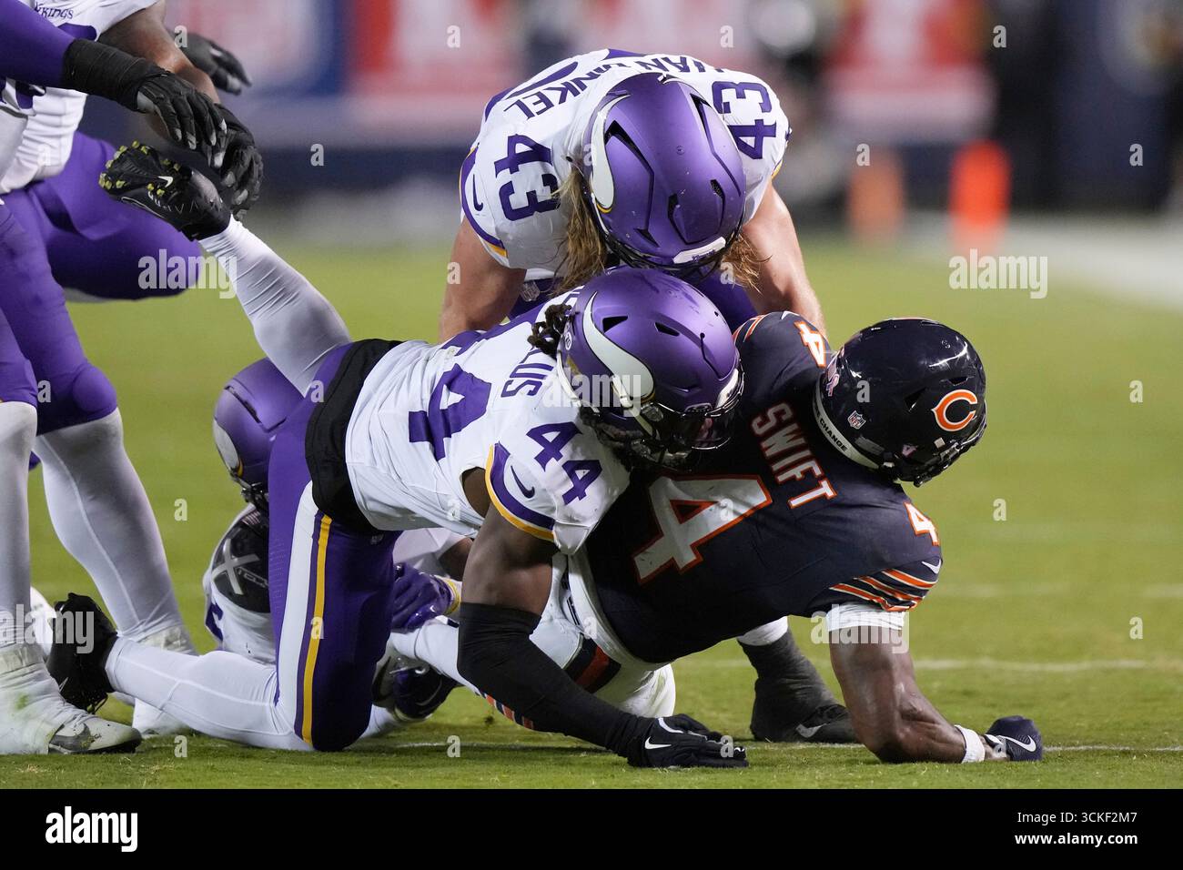Chicago Bears running back D'Andre Swift (4) is tackled by Minnesota Vikings safety Joshua ...