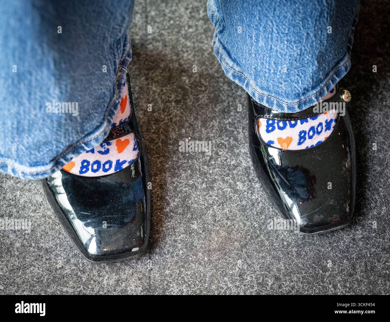 11 September 2025, Berlin: A visitor wears socks with hearts and the ...