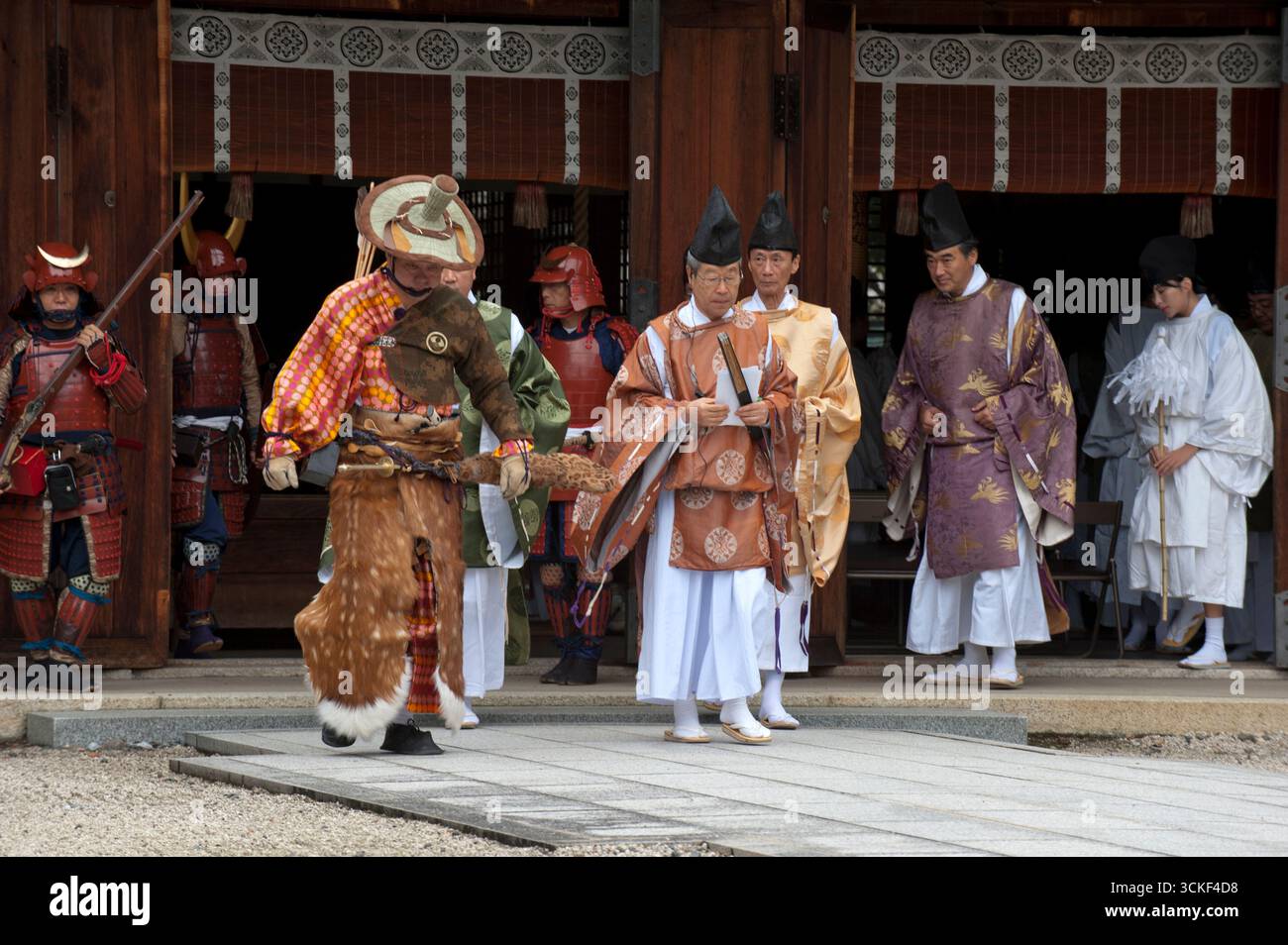 Yabusame horseback archers holding bows and arrows after receiving a ...