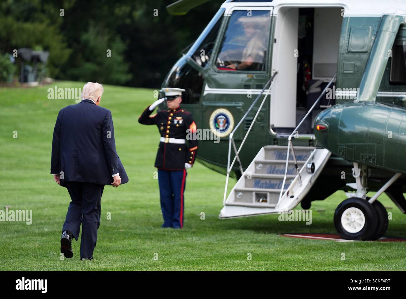 President Donald Trump walks to board Marine One on the South Lawn of ...