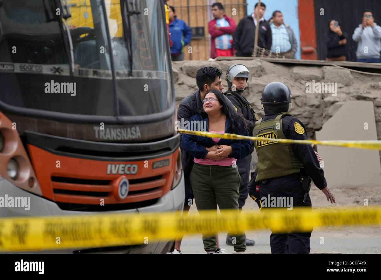 Relatives of bus driver Arturo Ramon cry next the bus where he was ...