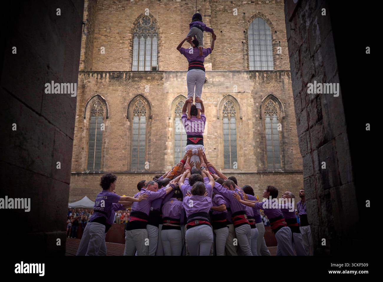 Members of a "Casteller" form a "Castell" or human tower during the ...