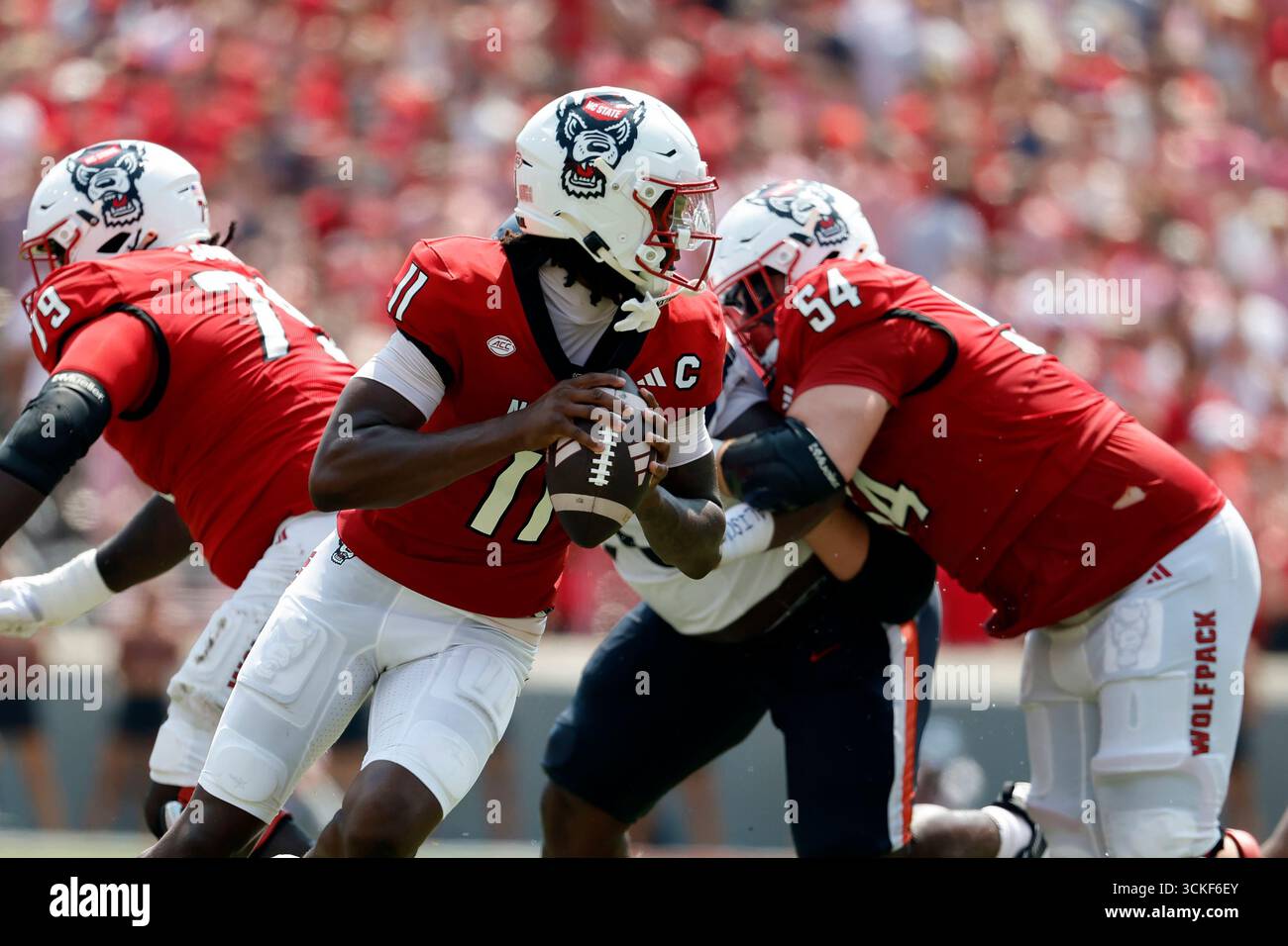 North Carolina State quarterback CJ Bailey (11) scrambles with the ball ...