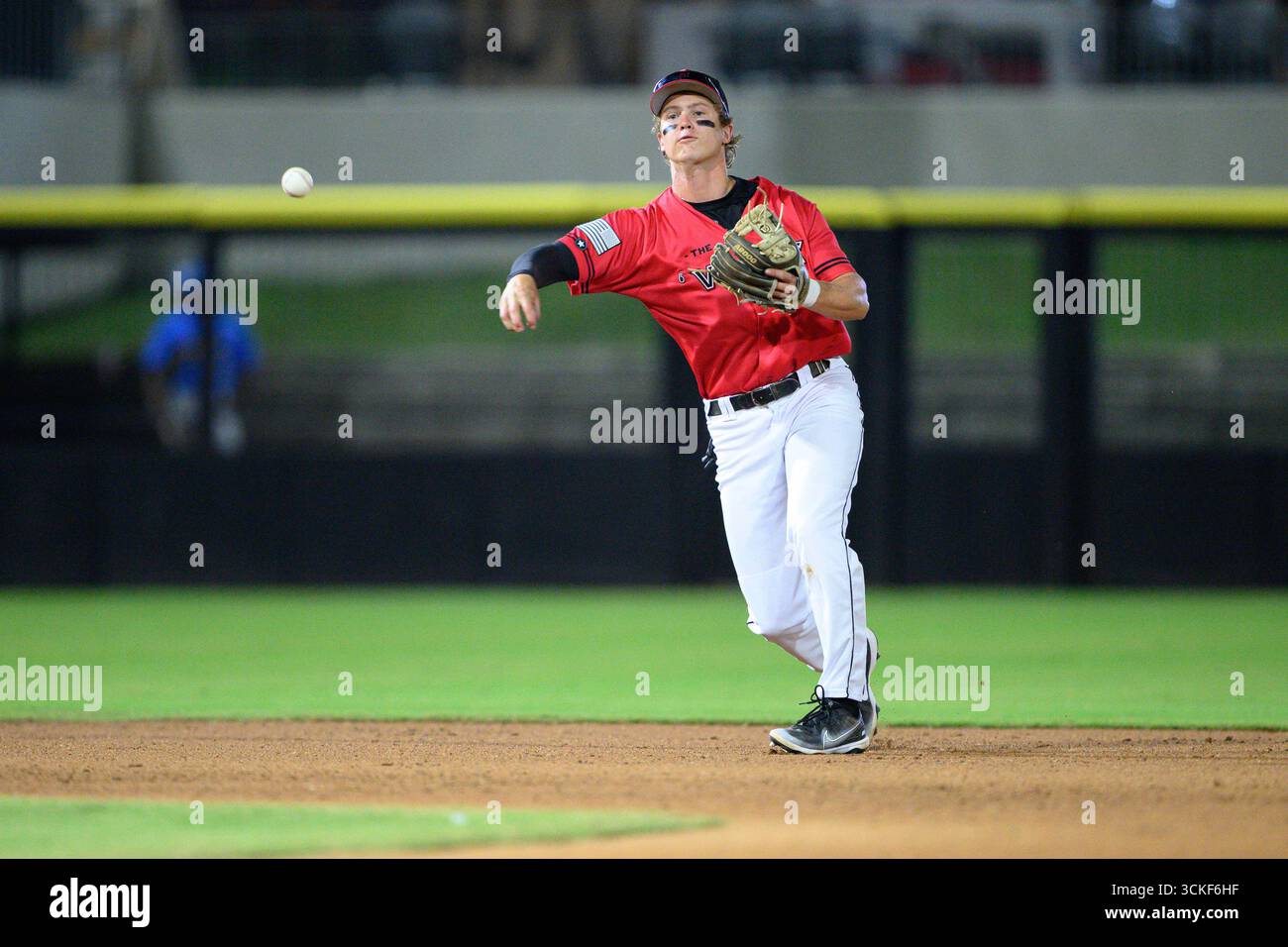 Shortstop Zach Daudet (26) of the Fayetteville Woodpeckers makes a throw to first base during a ...