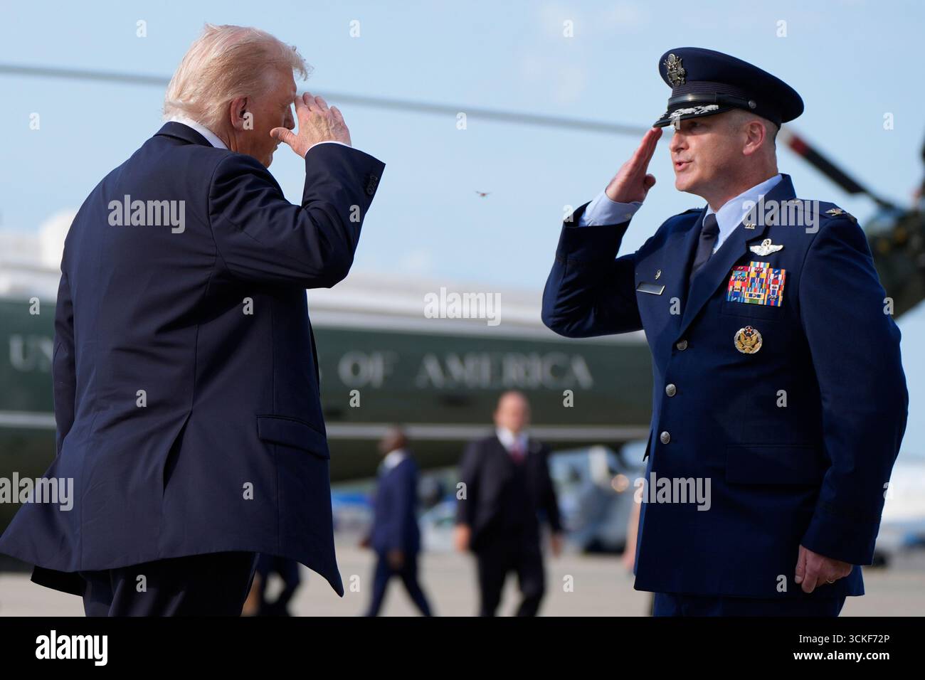 President Donald Trump salutes Col. Christoper Robinson, commander of ...