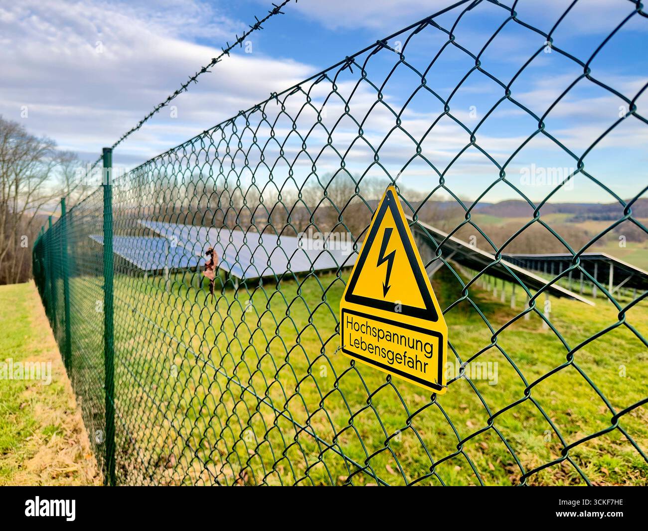 Renewable energy solar farm taken behind a securing fence with a high ...
