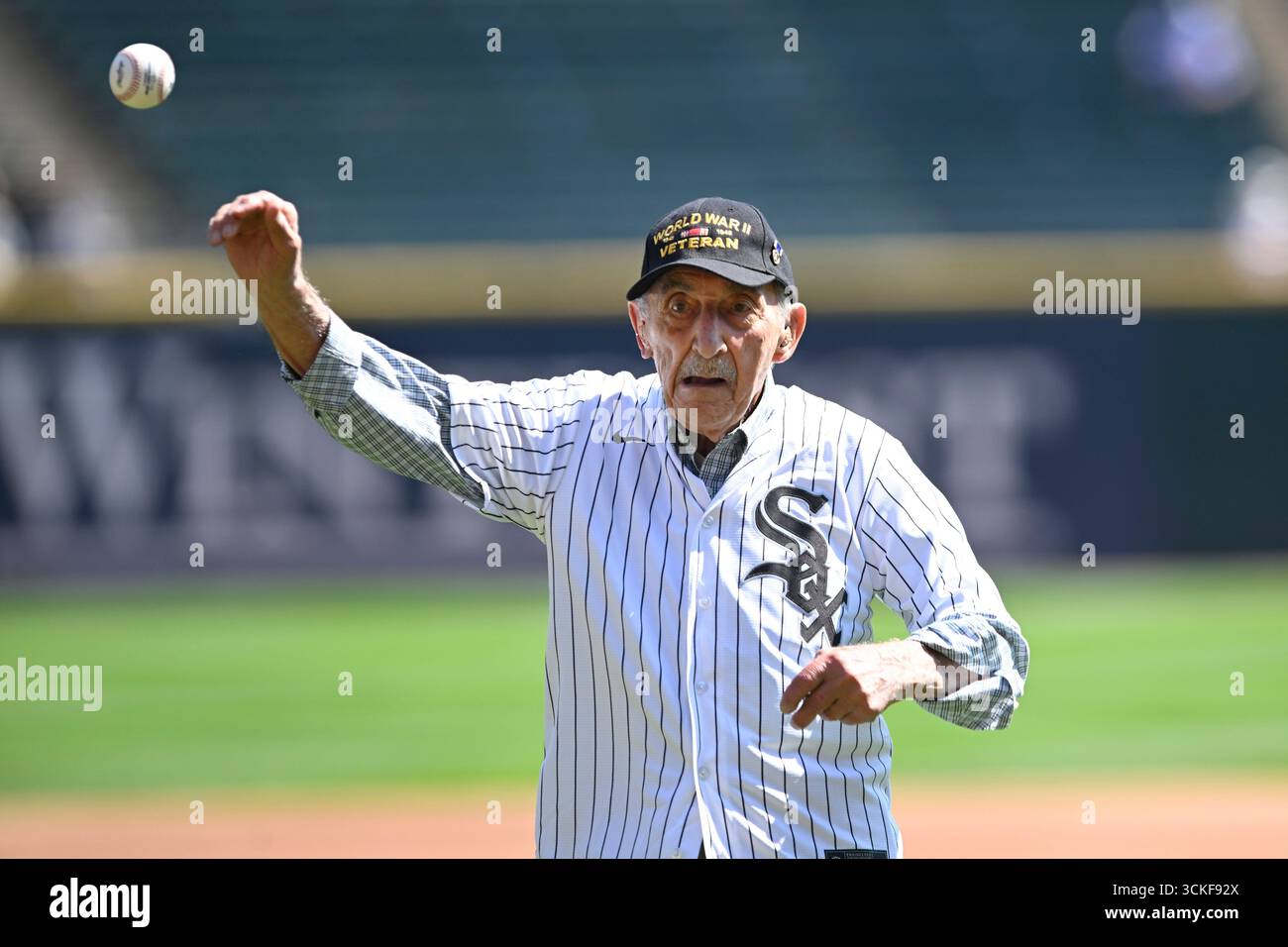 World War II veteran Tony Figlioli throws out a ceremonial first pitch ...