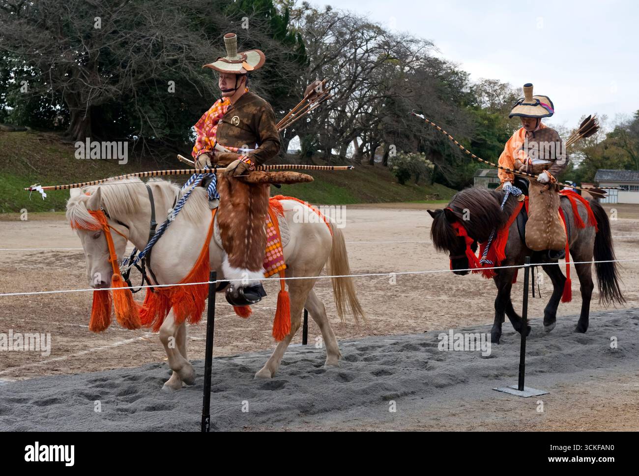 Japanese archers on horseback returning from shooting arrows at a target during a mounted ...