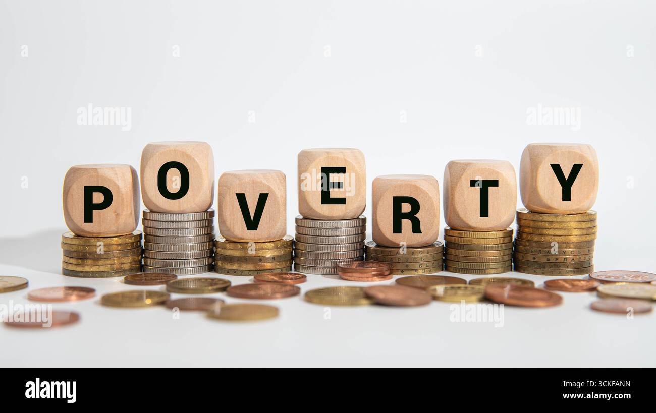 Poverty word written on wood block. Poverty text on cement table for ...