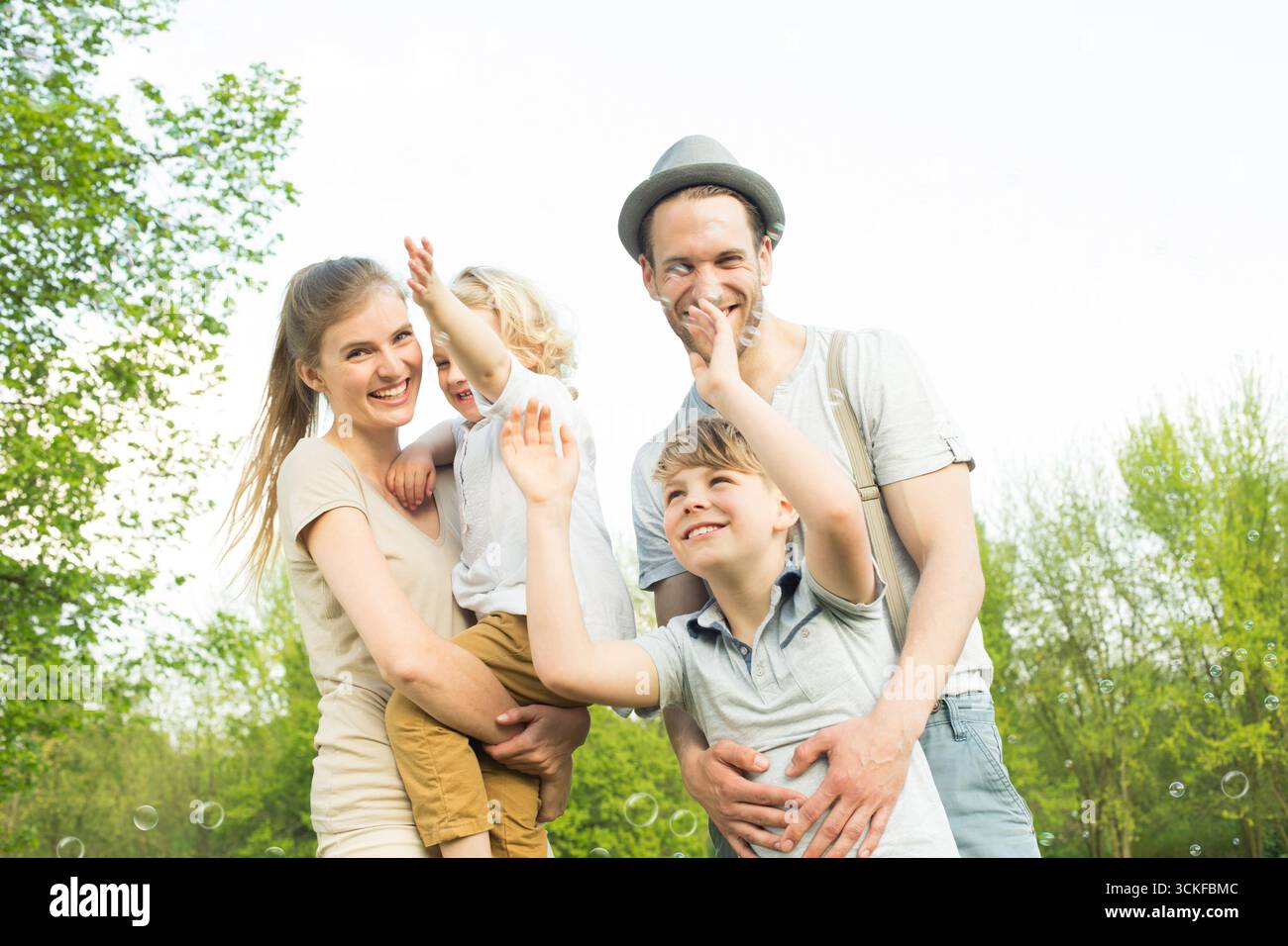 Family with two children on a meadow Stock Photo - Alamy