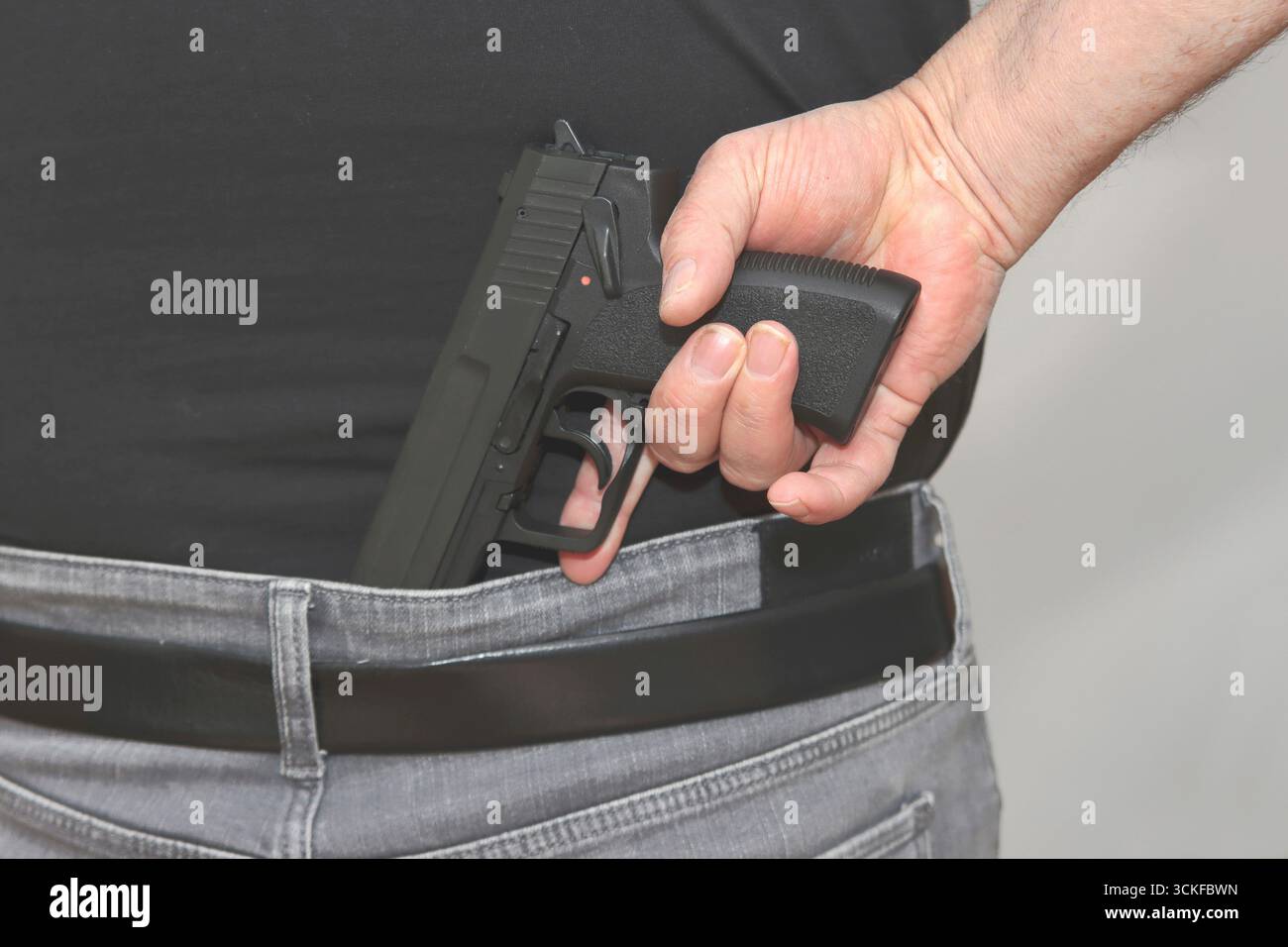 Holstering pistol hi-res stock photography and images - Alamy