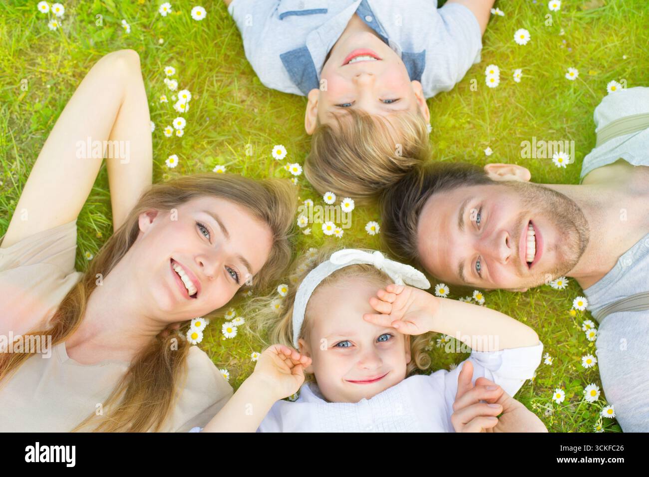 Family with two children on a meadow Stock Photo - Alamy