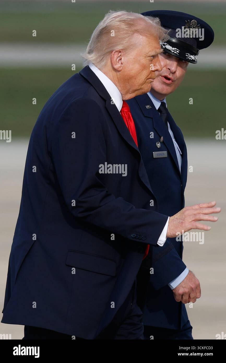 President Donald Trump, left, is escorted by Air Force Col. Christopher ...